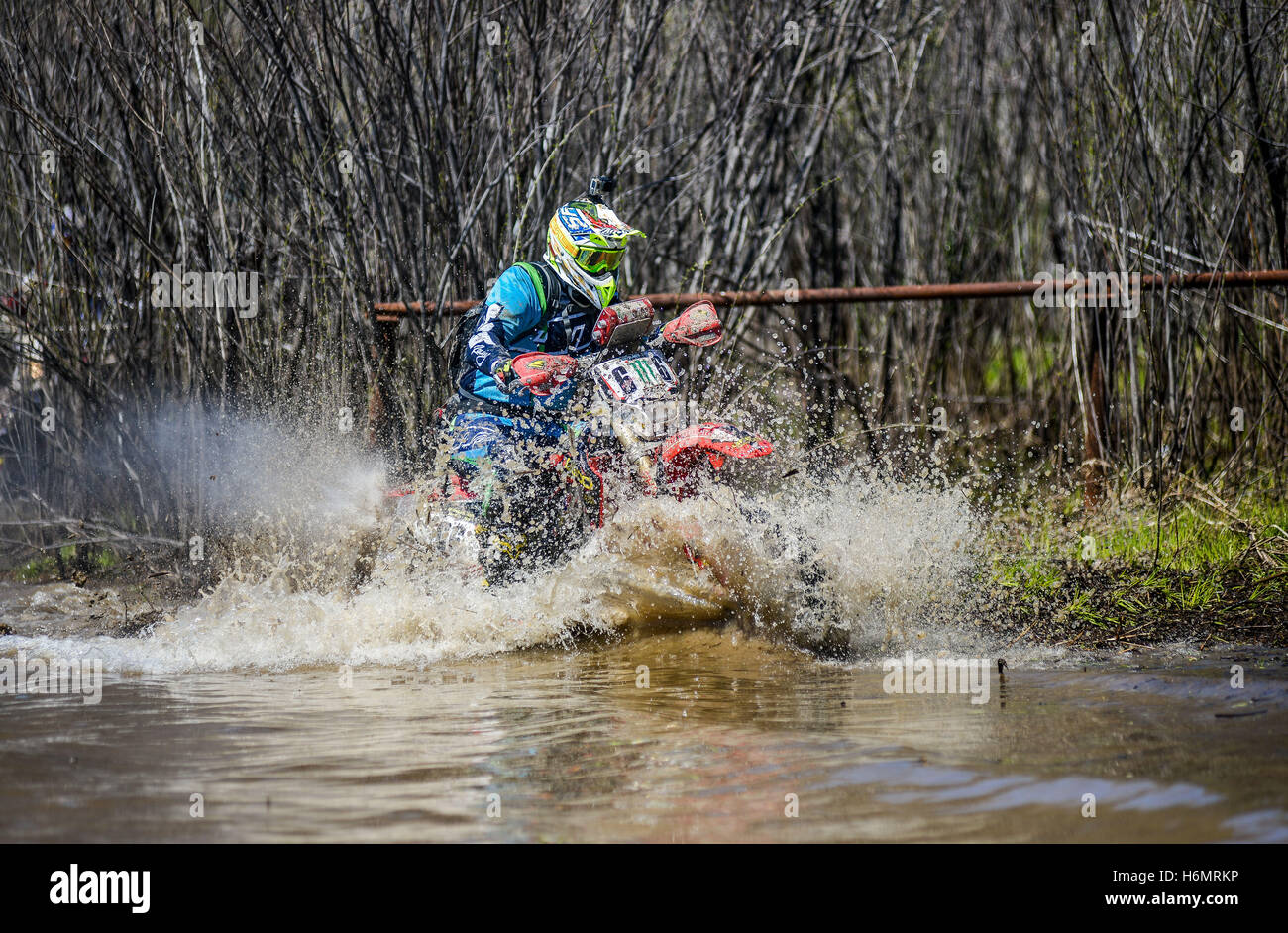 Enduro motorcycle rides through the mud with a big splash Stock Photo ...