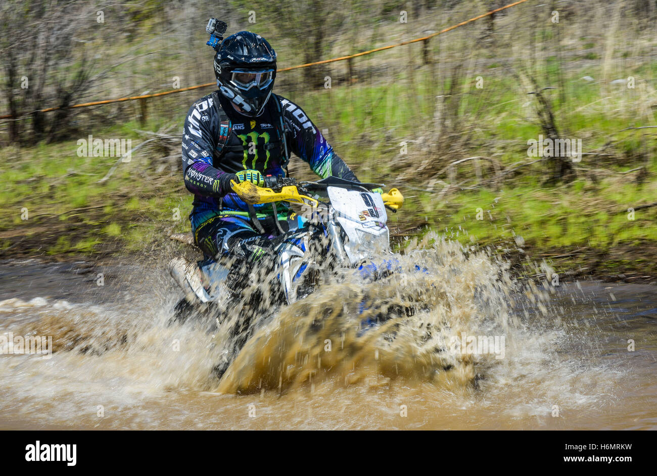 Enduro motorcycle rides through the mud with a big splash Stock Photo ...