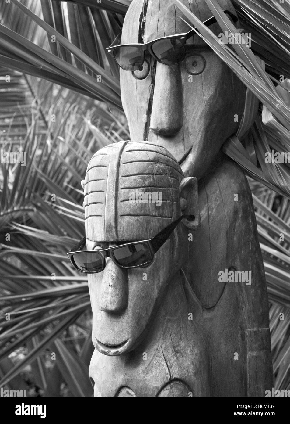 Polynesian carved wooden idols in sunglases Stock Photo - Alamy