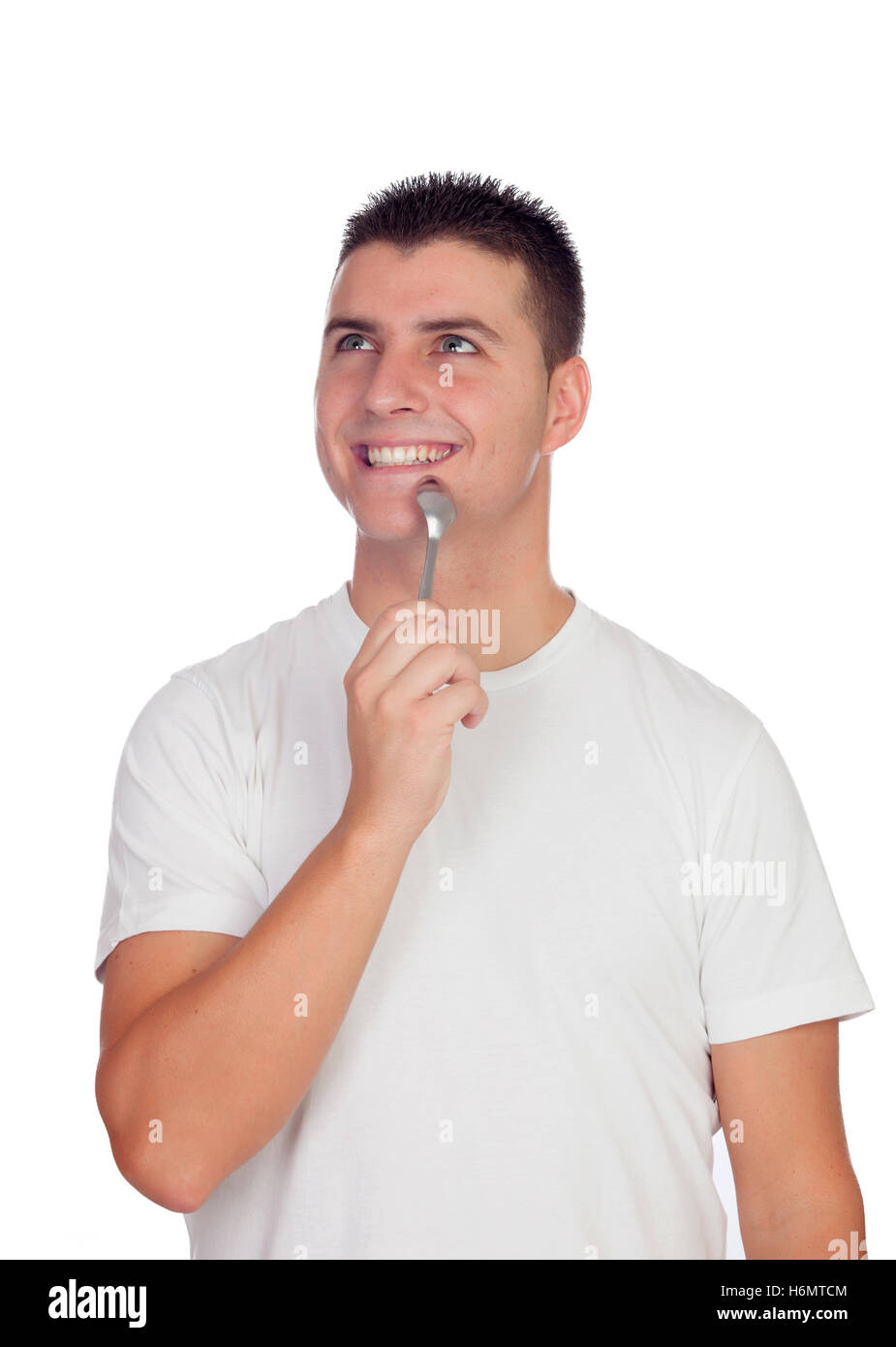 Pensive young men with a spoon isolated on a white background Stock ...
