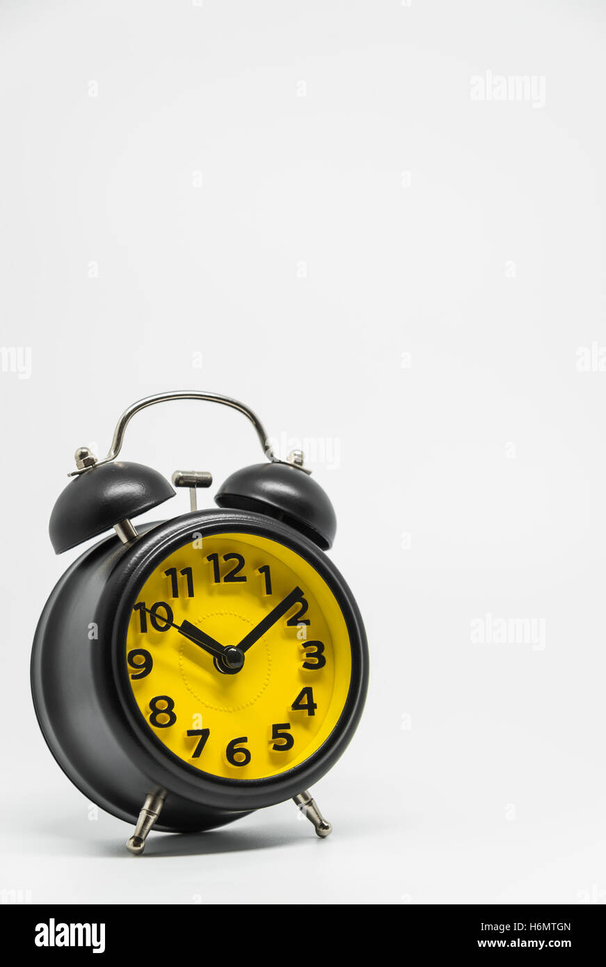 Black vintage retro style alarm clock on white background and selective ...