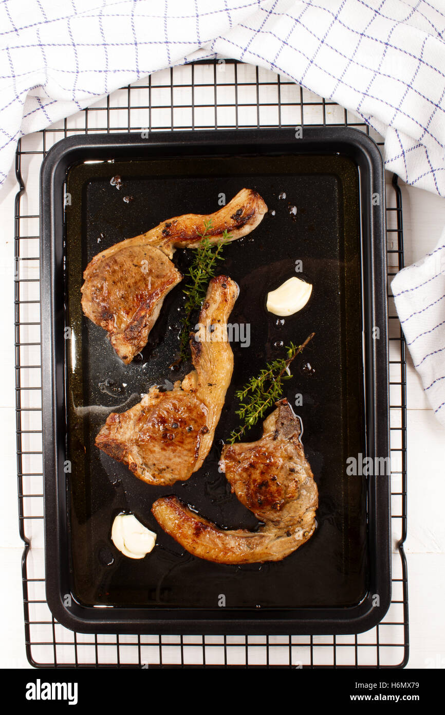roasted lamb chops on a roasting tray with garlic and thyme Stock Photo ...