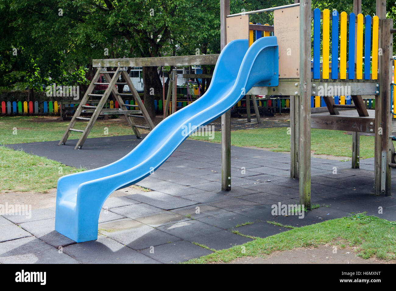 Blue toboggan in the middle of a playground without children Stock ...