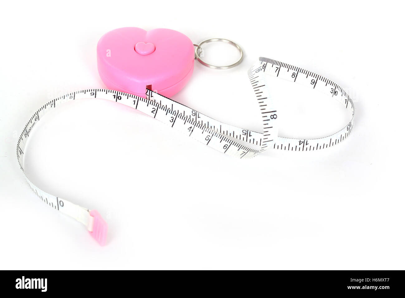 Measuring tape in heart roll Stock Photo - Alamy