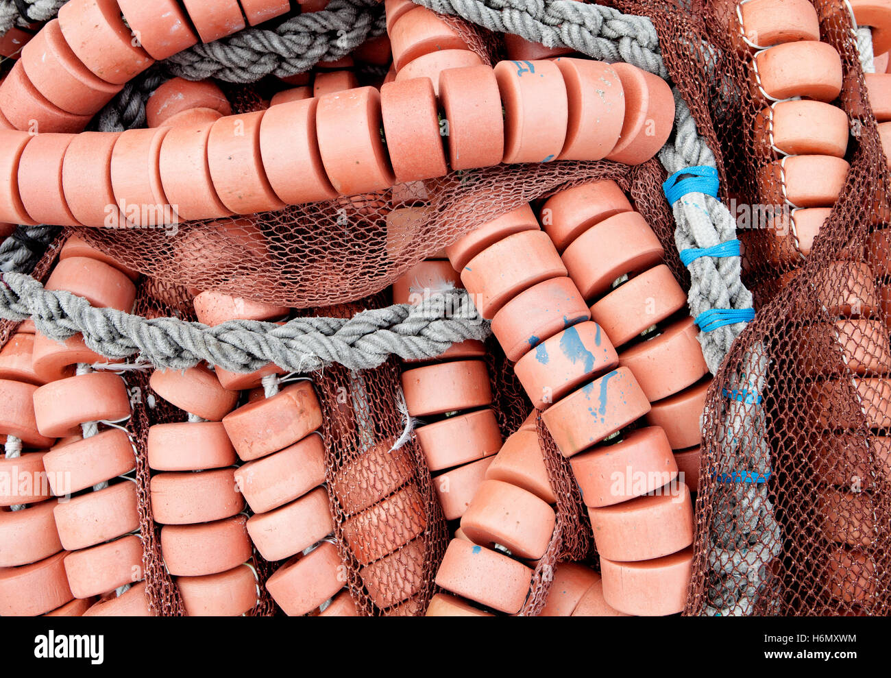 Fishing nets stacked waiting to return to sea Stock Photo - Alamy