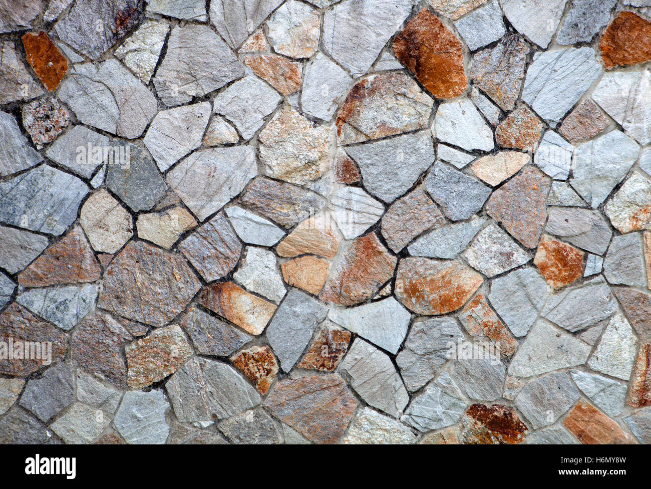 Gray stone wall with built building with a pattern Stock Photo - Alamy