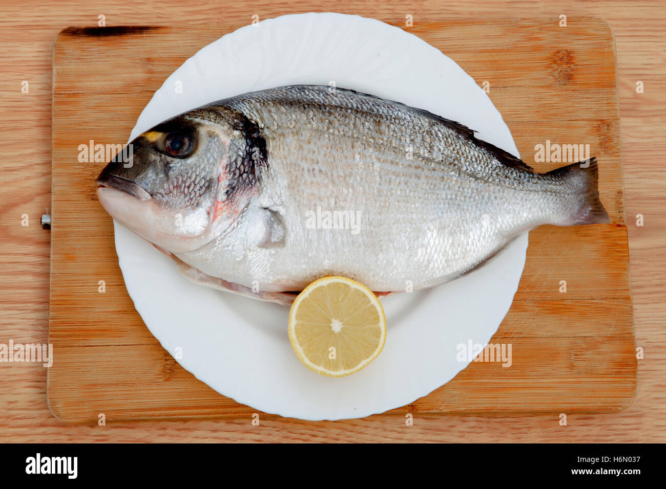 Photo of a healthy fresh fish on wooden board Stock Photo - Alamy