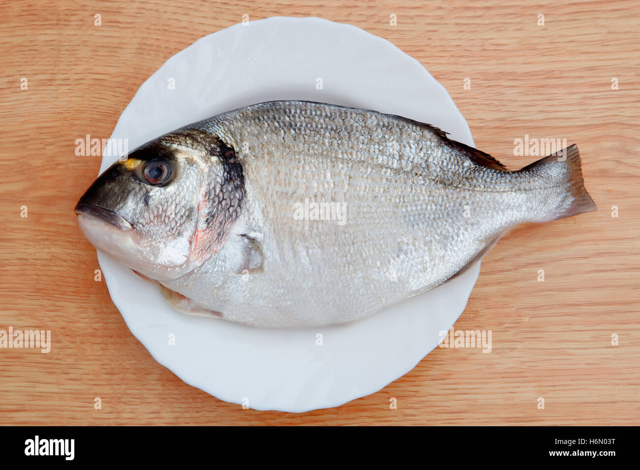 Photo of a healthy fresh fish on wooden board Stock Photo - Alamy
