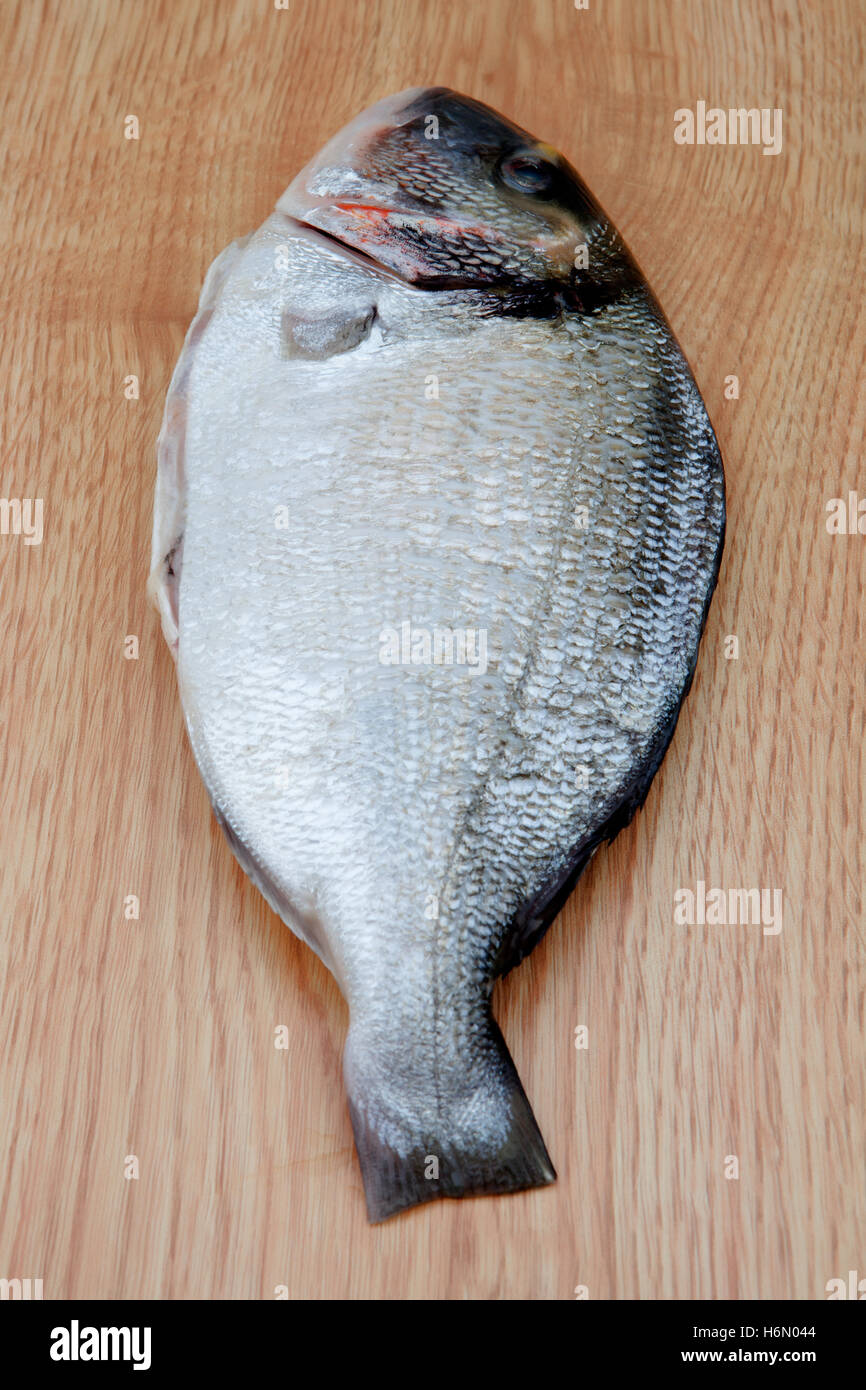 Photo of a healthy fresh fish on wooden board Stock Photo - Alamy