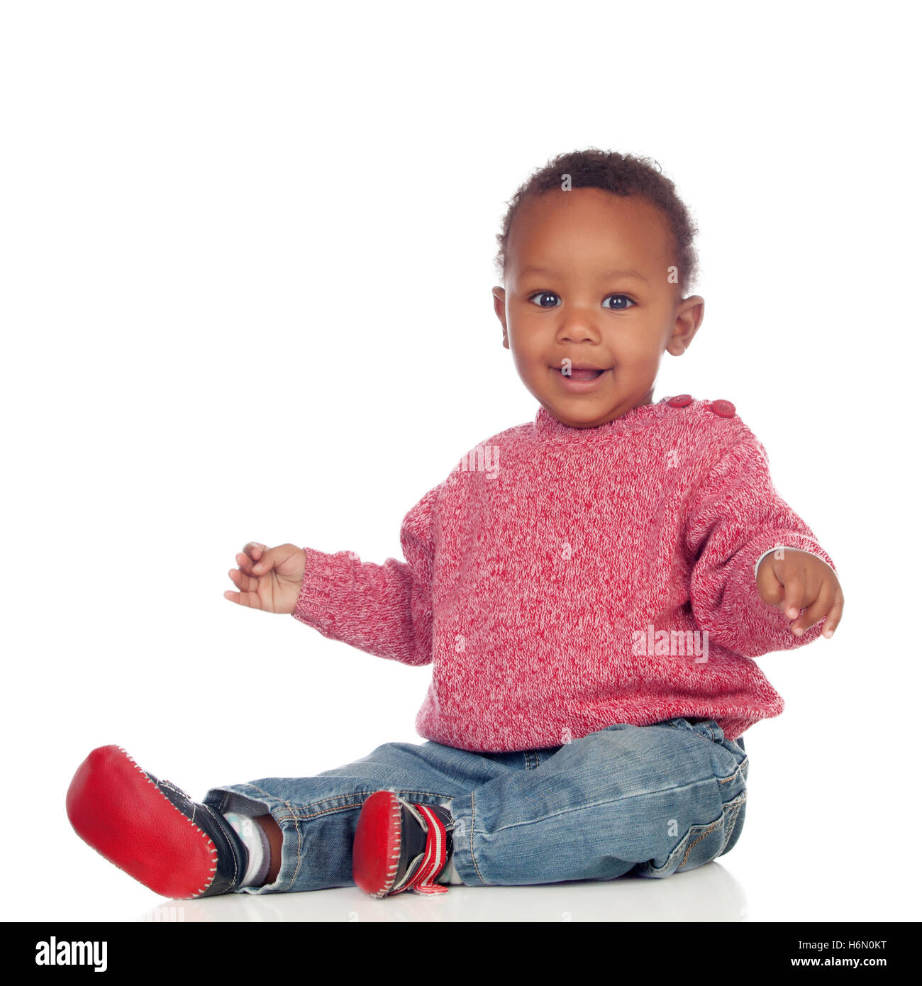 Adorable african baby sitting on the floor isolated on a white ...
