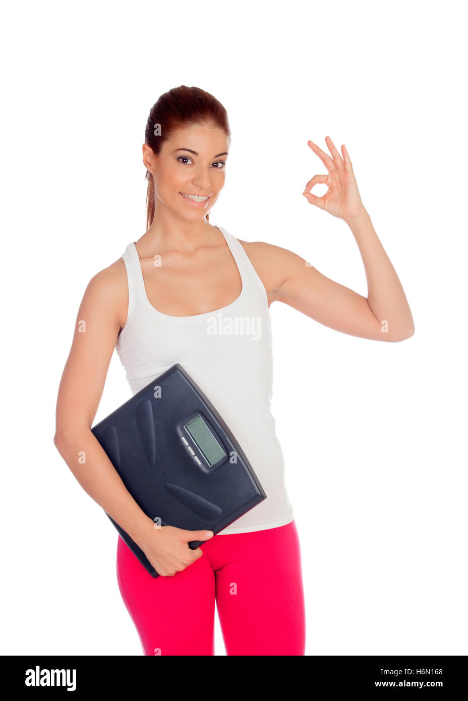 Slim woman with a scale in his arms saying Ok isolated on a white ...