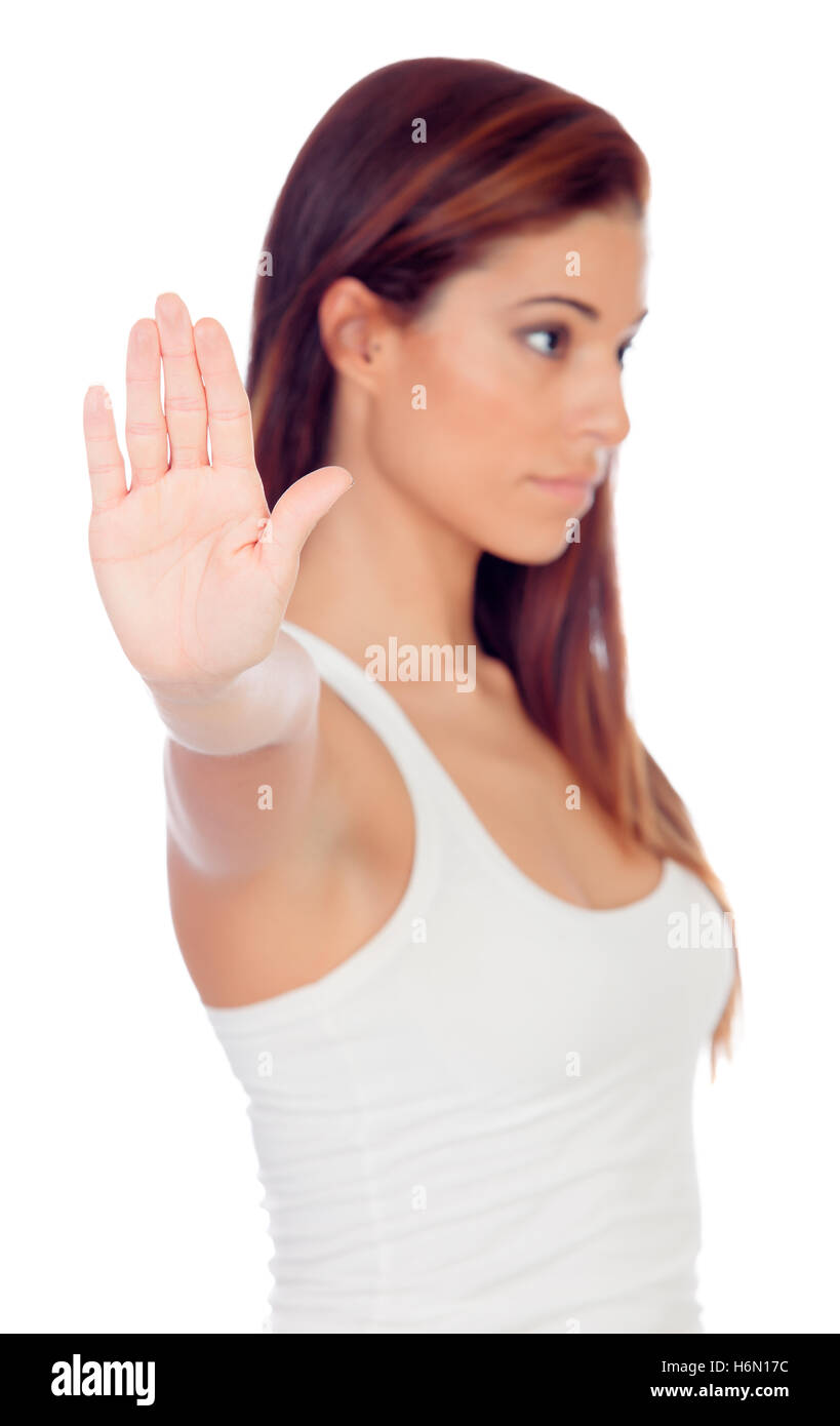 Serious woman making a stop sign with her hand isolated on a white ...