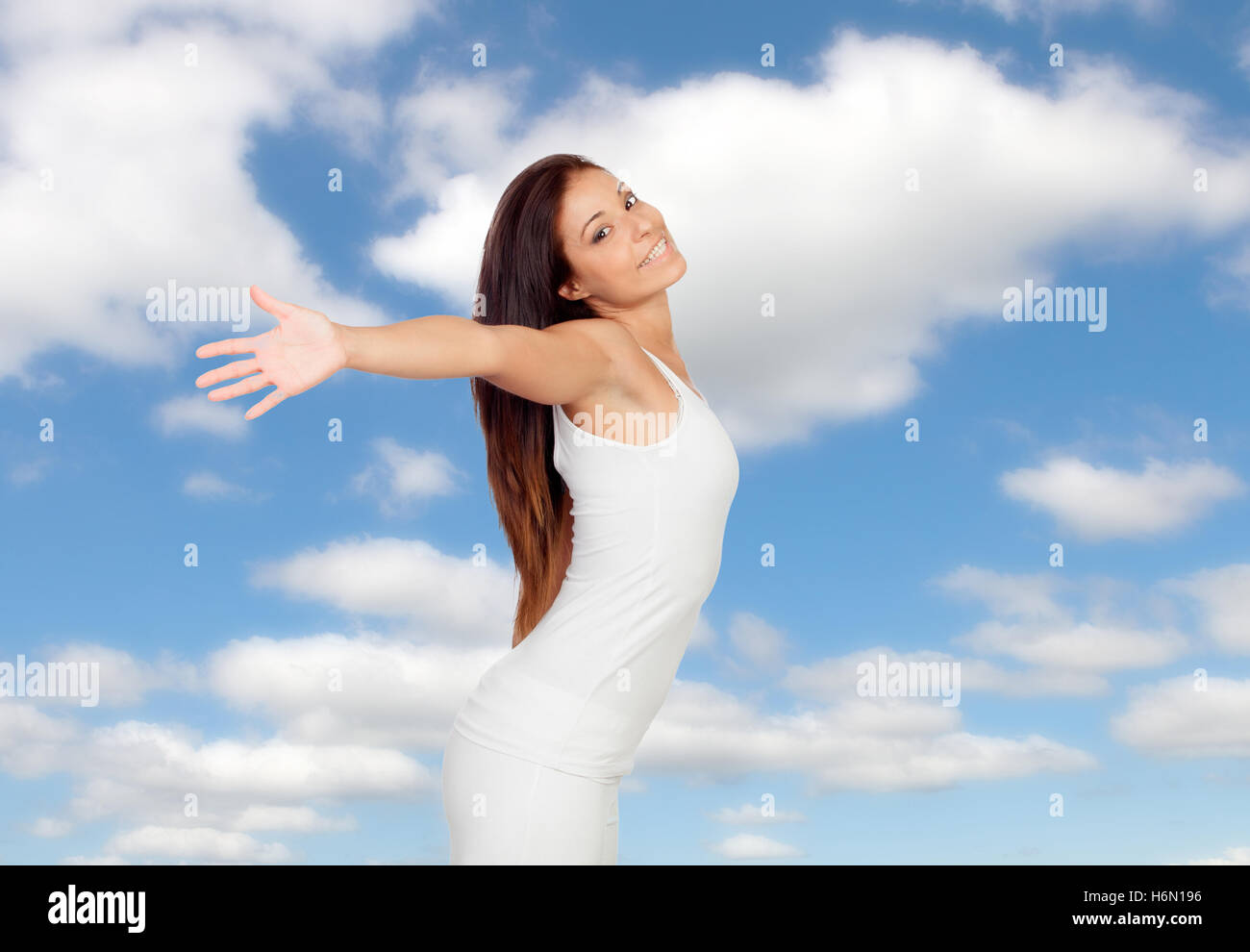 Woman expressing her freedom over a blue sky with clouds Stock Photo ...