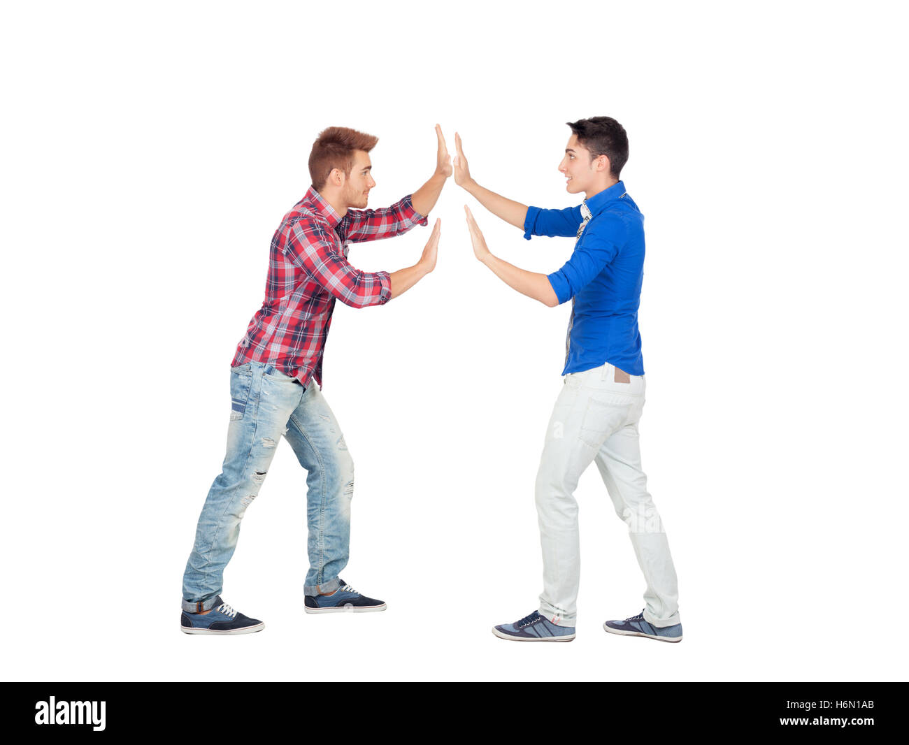 Two faced young men isolated on white background Stock Photo - Alamy