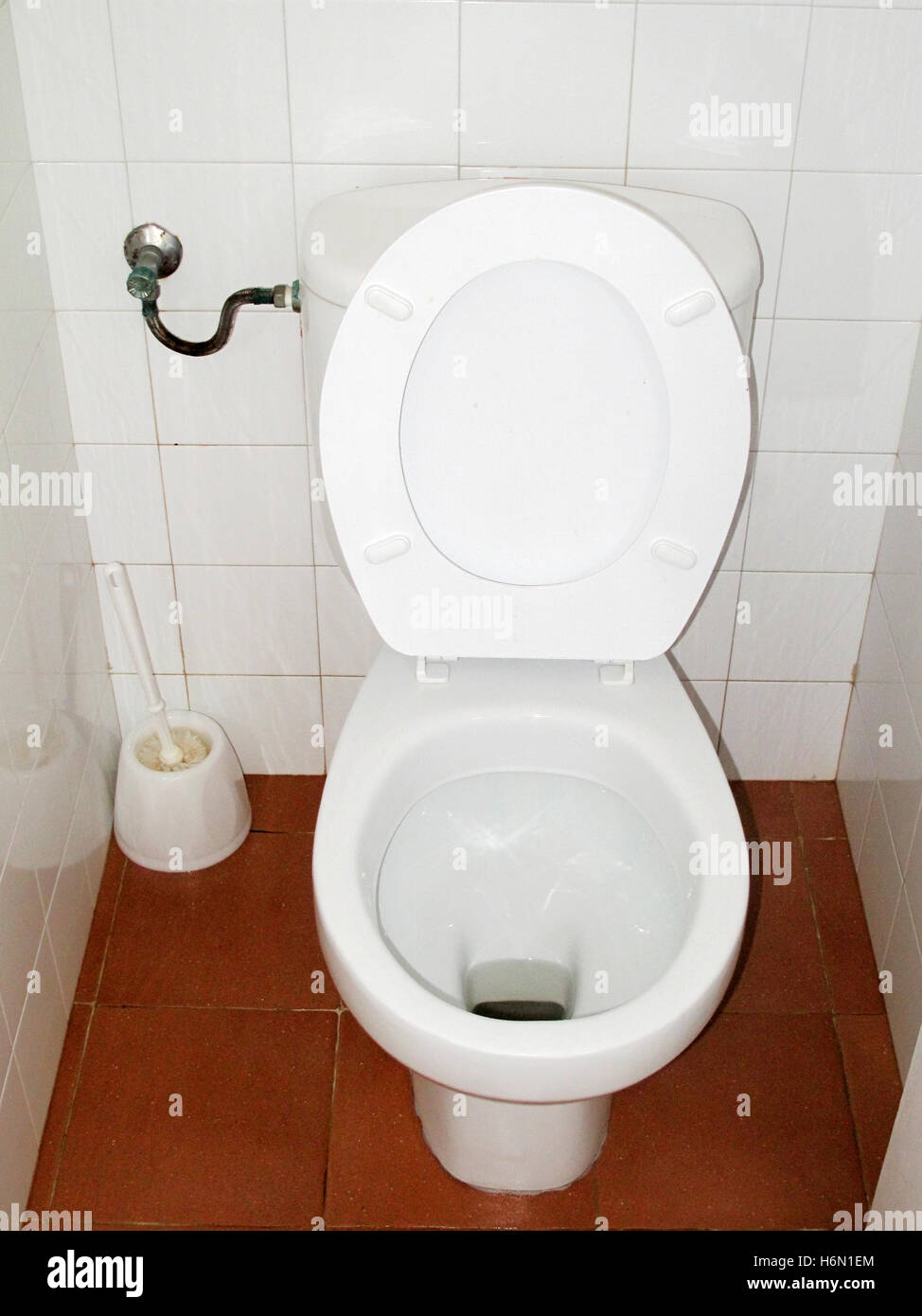 Small and simple toilet with a brush of battery Stock Photo - Alamy
