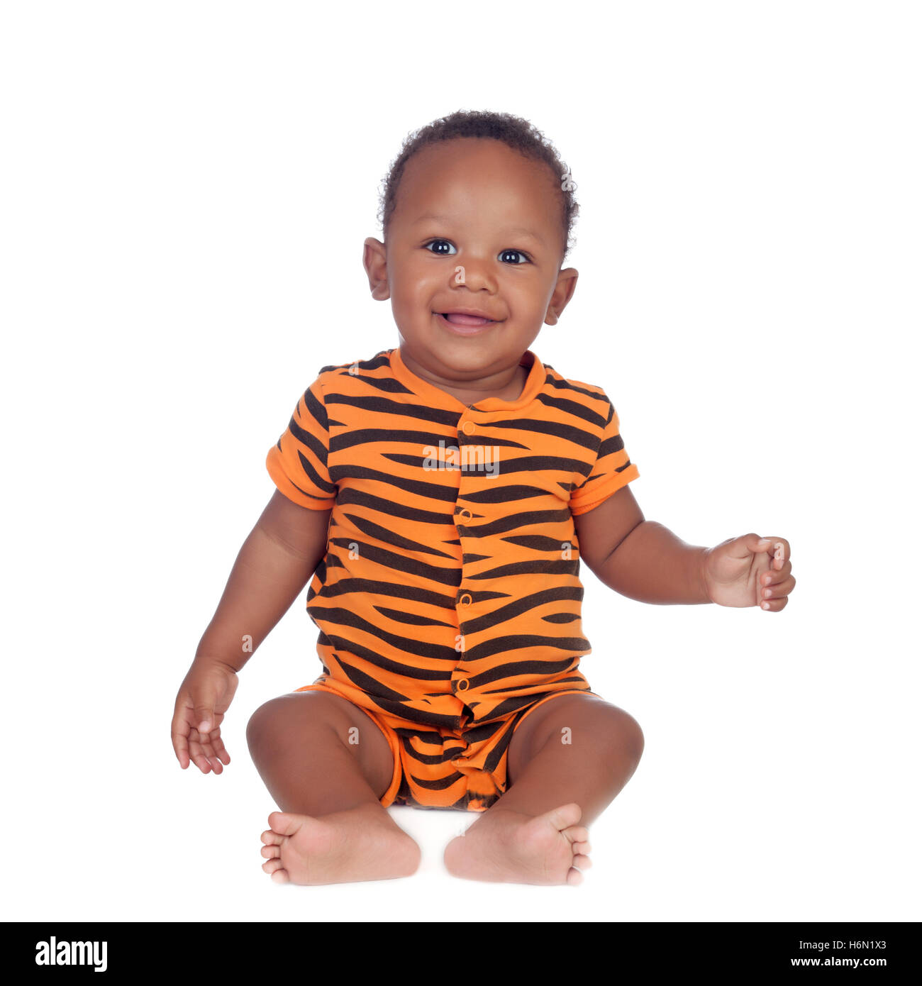 Adorable african baby with with brindle pajamas sitting on the floor ...