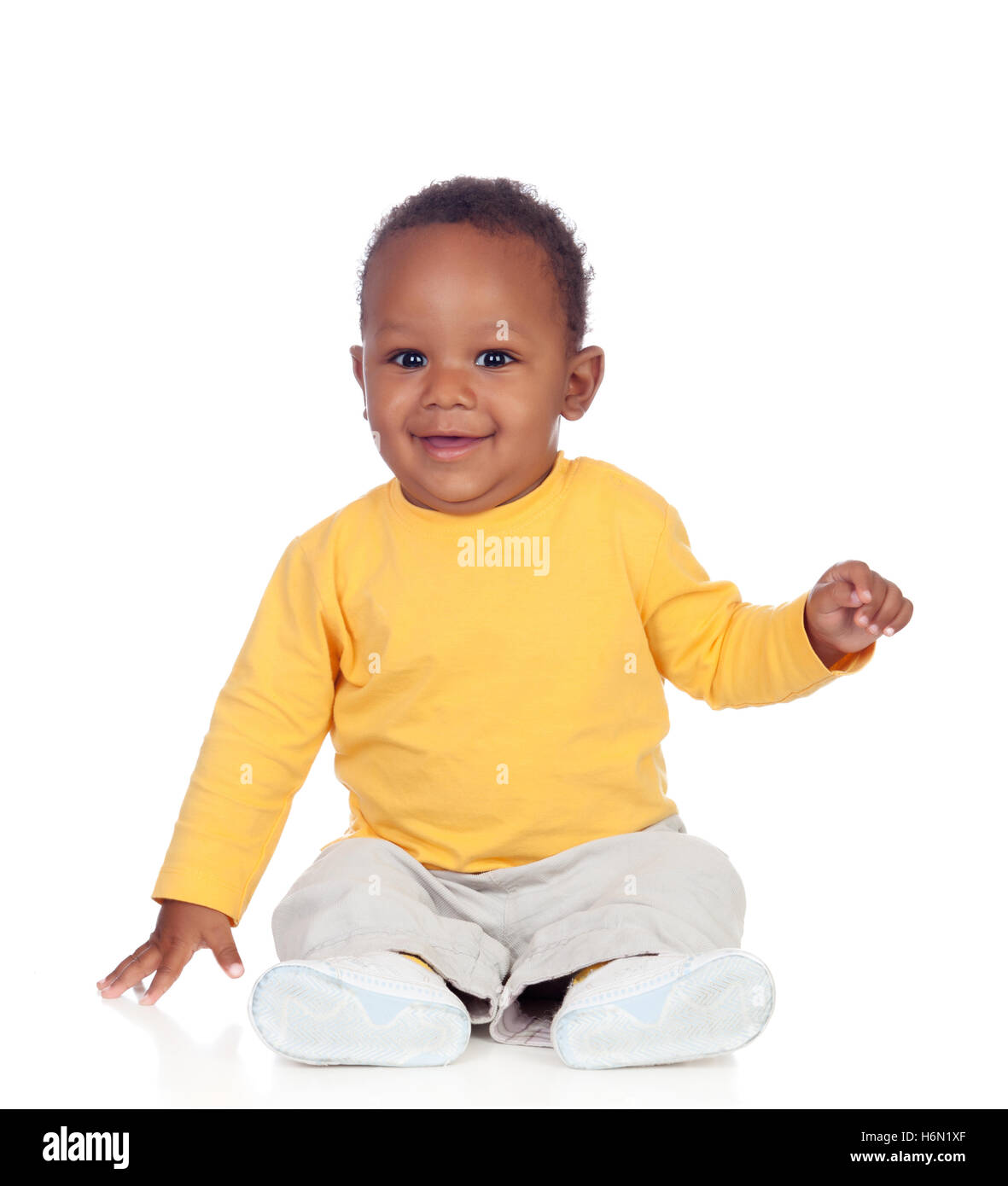 Adorable african baby sitting on the floor isolated on a white ...