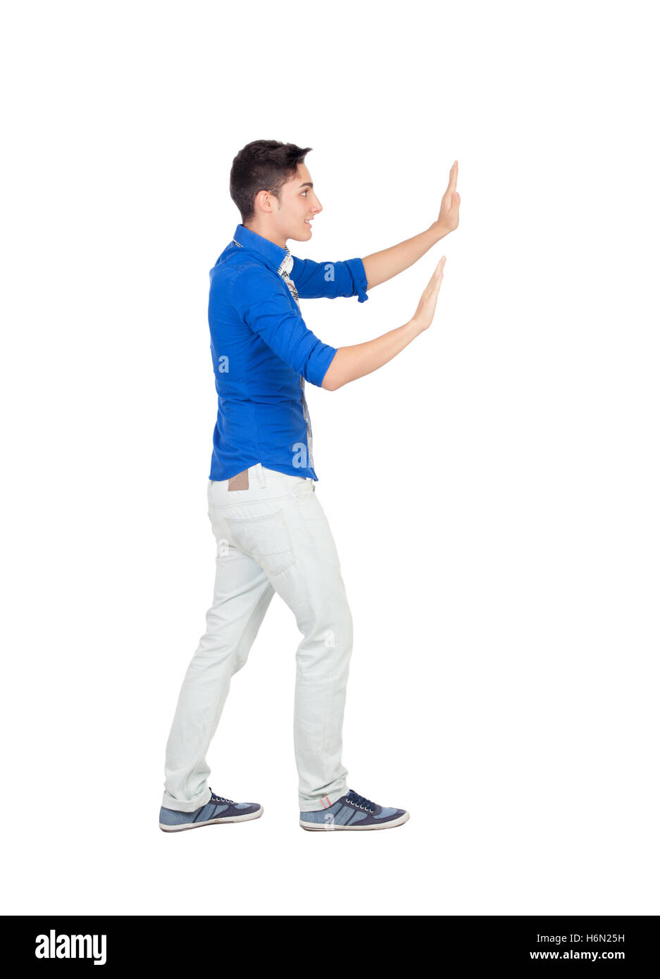 Young man pushing with blue shirt isolated on white background Stock ...