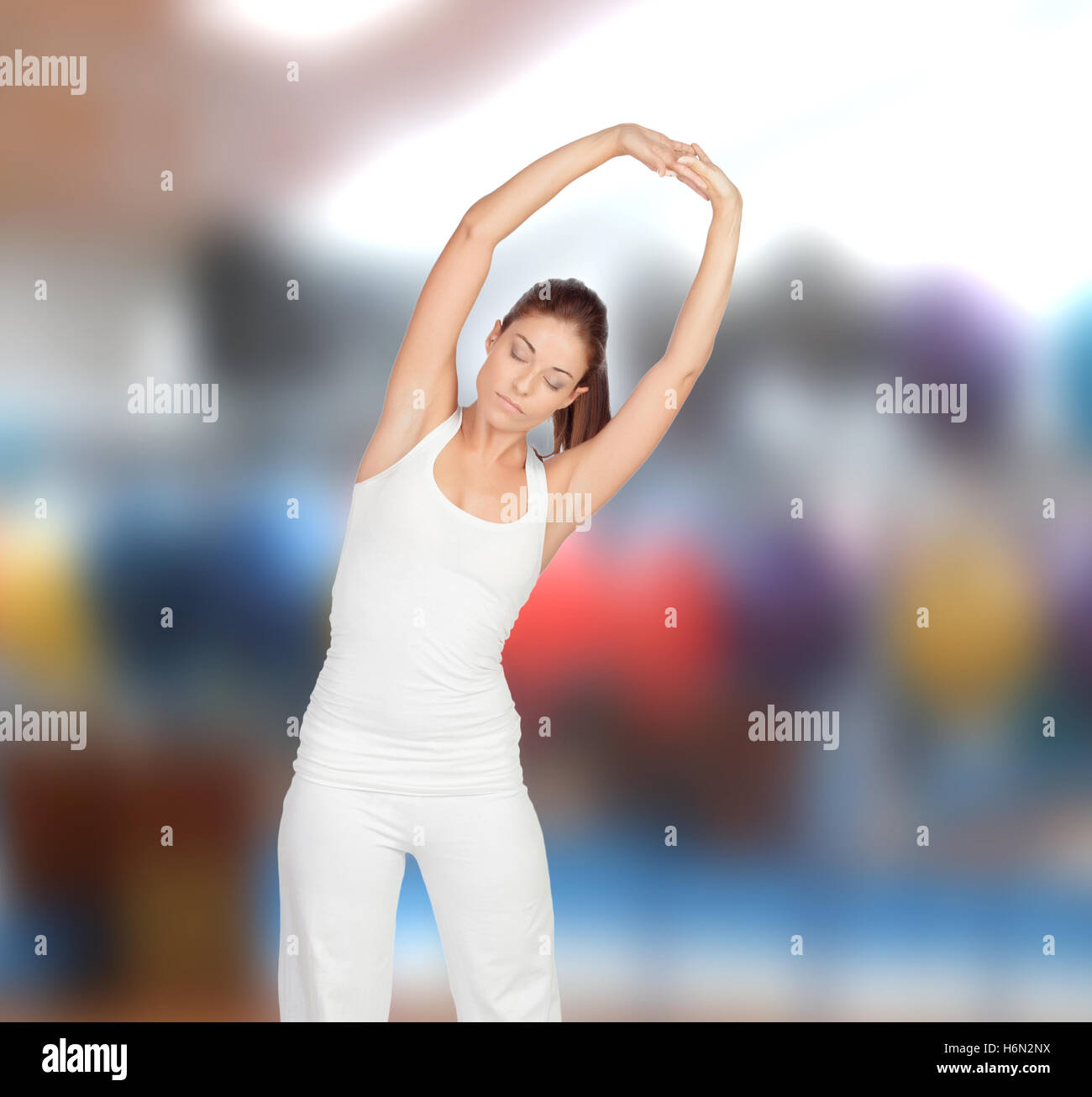 Relaxed woman stretching her arms in a pilates class Stock Photo - Alamy