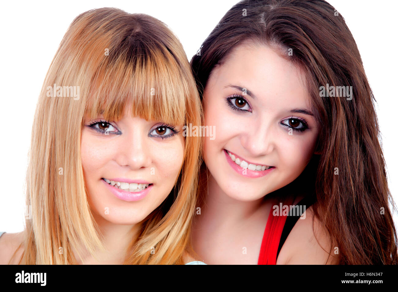 Two teen sisters isolated on white background Stock Photo - Alamy