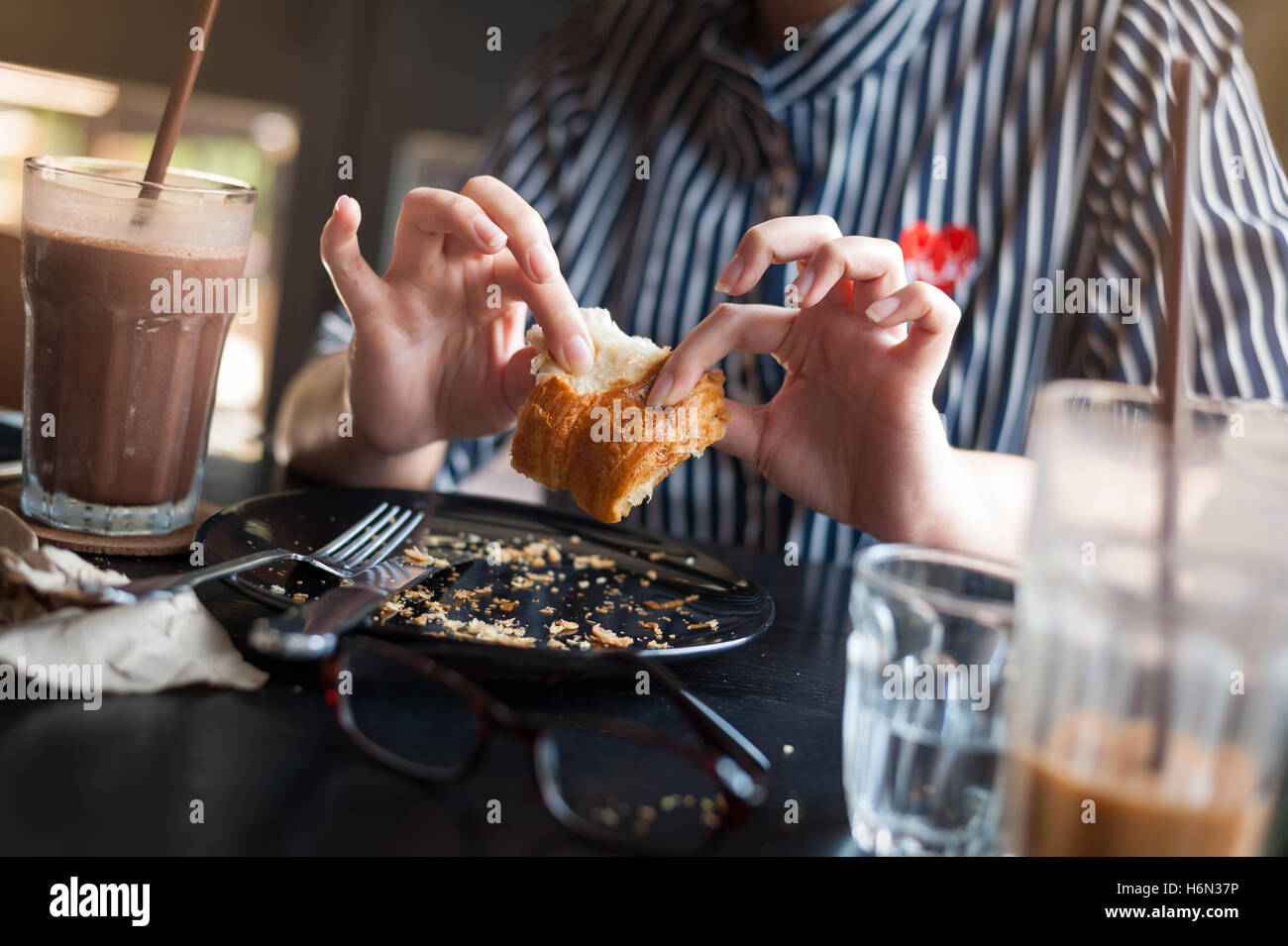 Weekend afternoon lifestyle and activity of young hipster woman eating ...