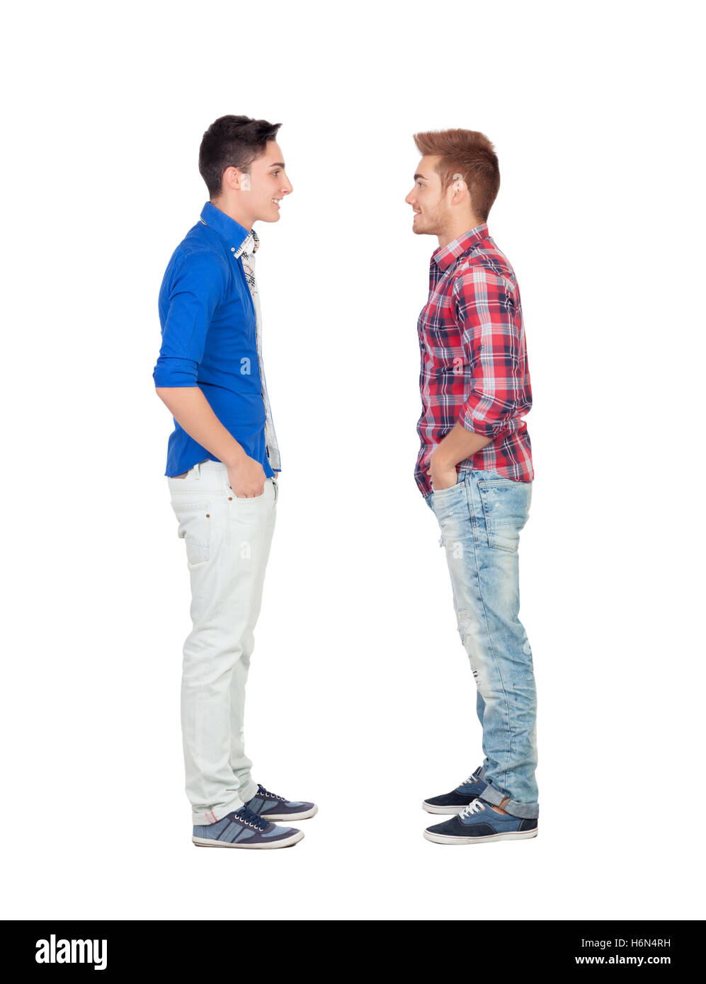 Portrait of two brothers face to face isolated on a white background ...