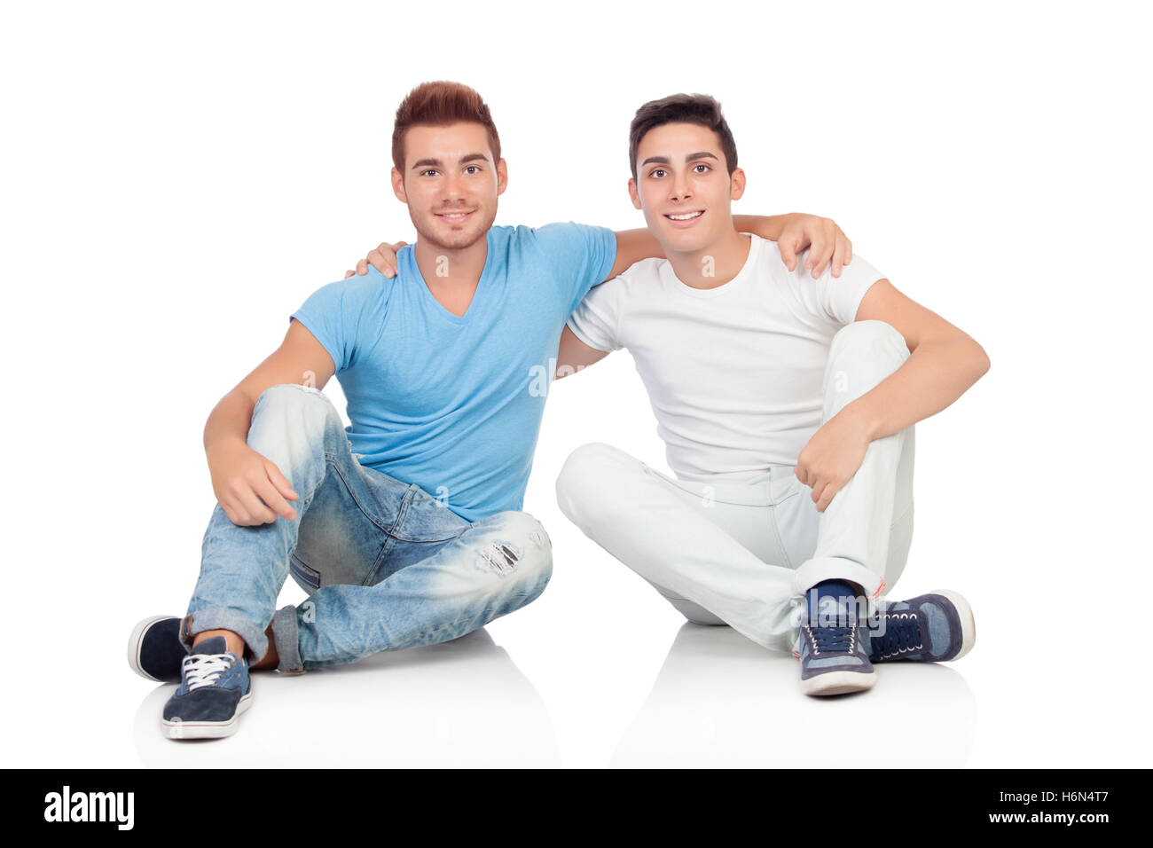 Portrait of two brothers sitting isolated on a white background Stock ...