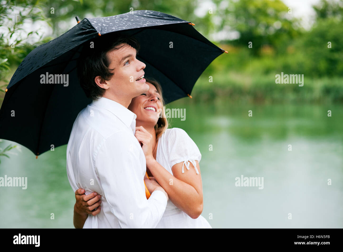Young couple hugging shower hi-res stock photography and images - Alamy