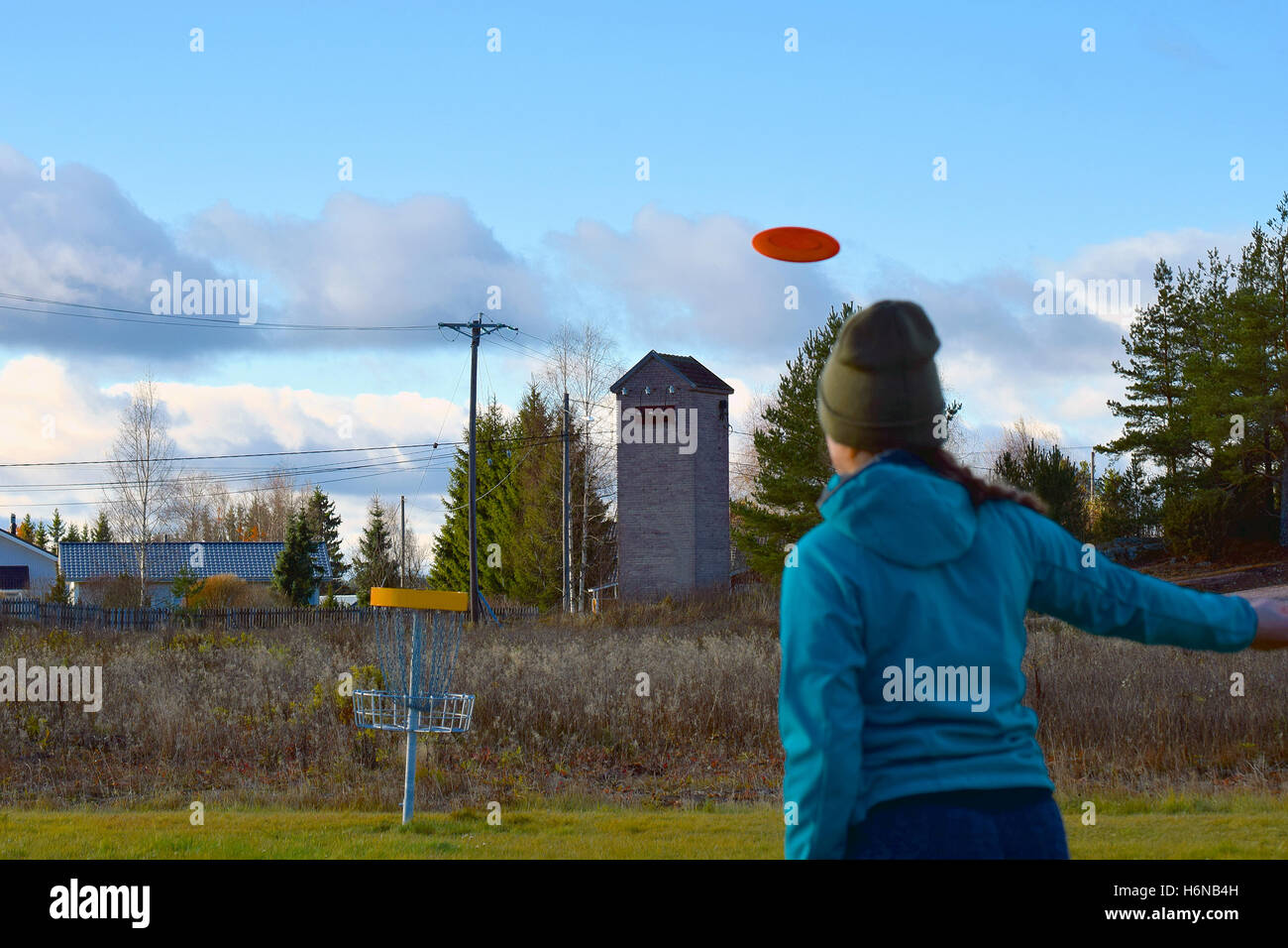 Teenager throwing disc golf on disc golf course Stock Photo - Alamy