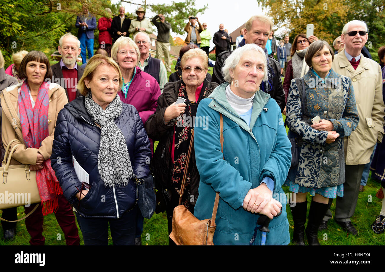 Local residents listening to opening remarks during the unveiling of a ...