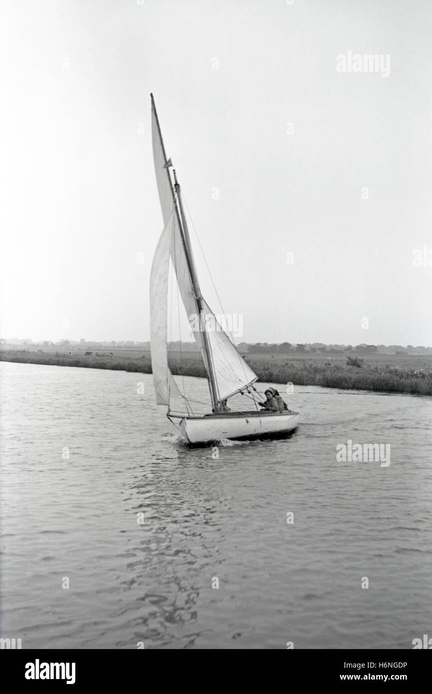 Small yacht sailing on river in Norfolk, England Stock Photo - Alamy