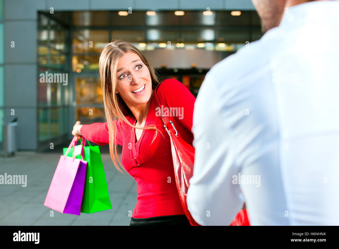 woman pulling man in shopping center Stock Photo - Alamy