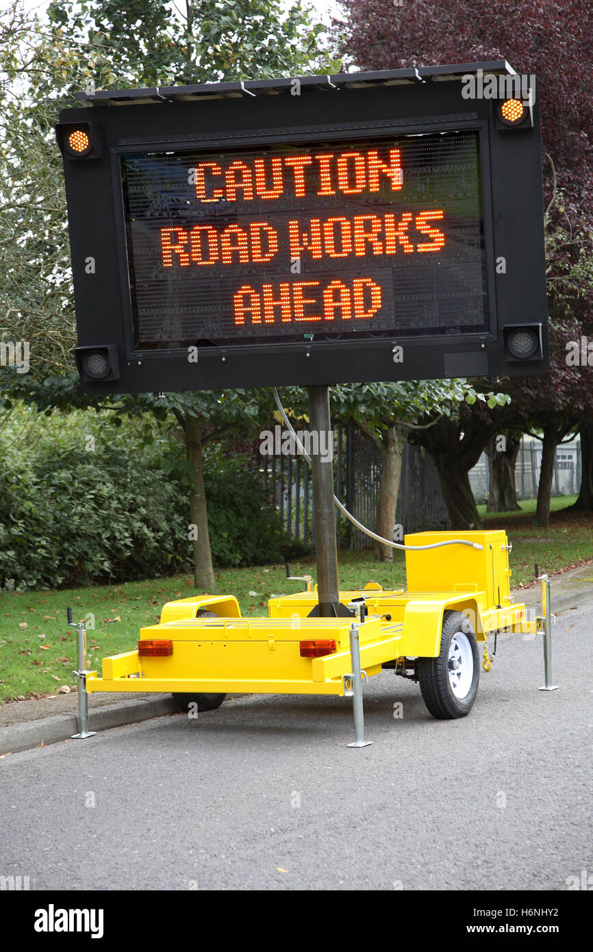 A roadside mobile, solar powered dot-matrix road sign shows the message ...