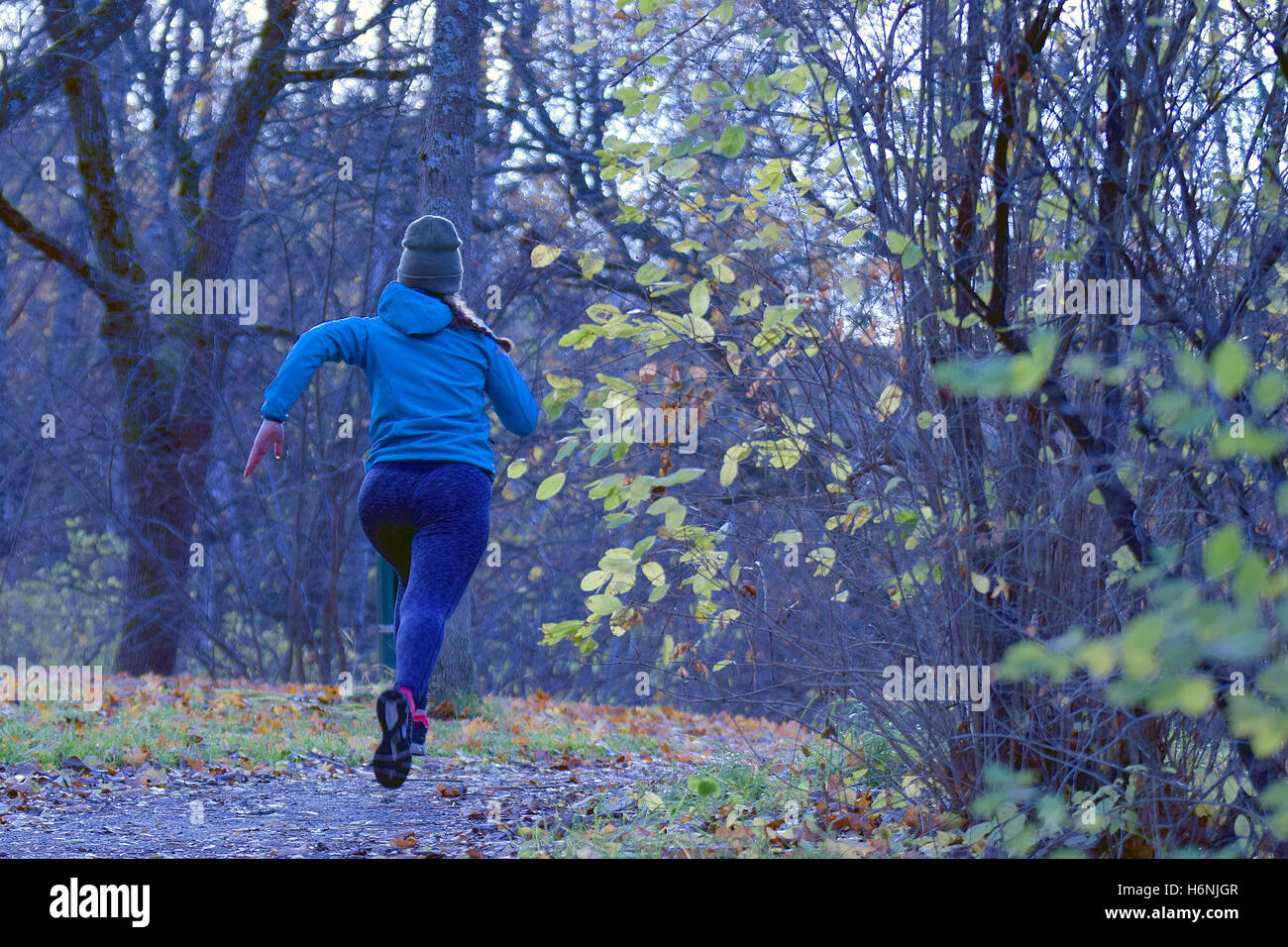 Running exercise. Teenager girl running in park Stock Photo - Alamy