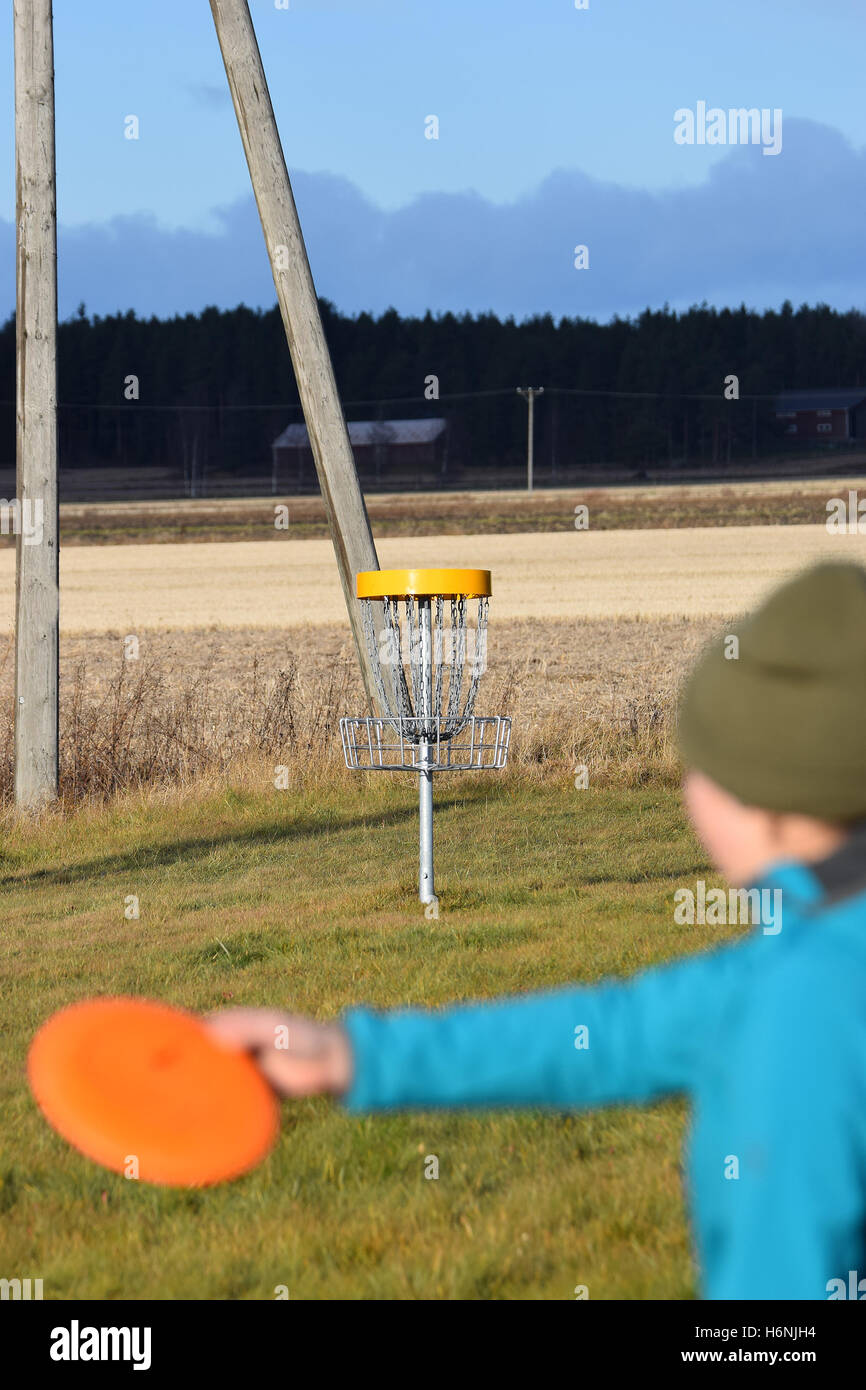 Young woman aiming disc on disc golf course. Focus in target Stock ...