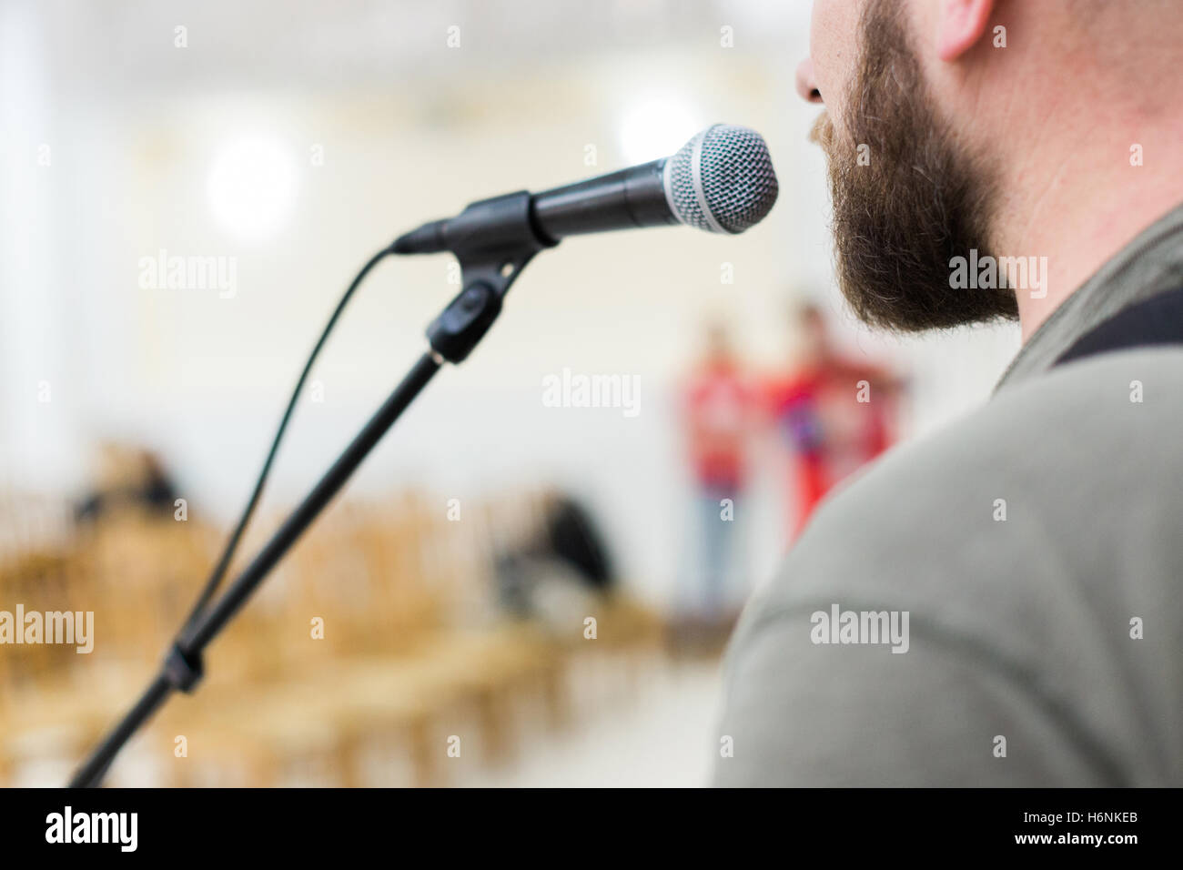 Man singing and playing acoustic guitar at concert Stock Photo - Alamy
