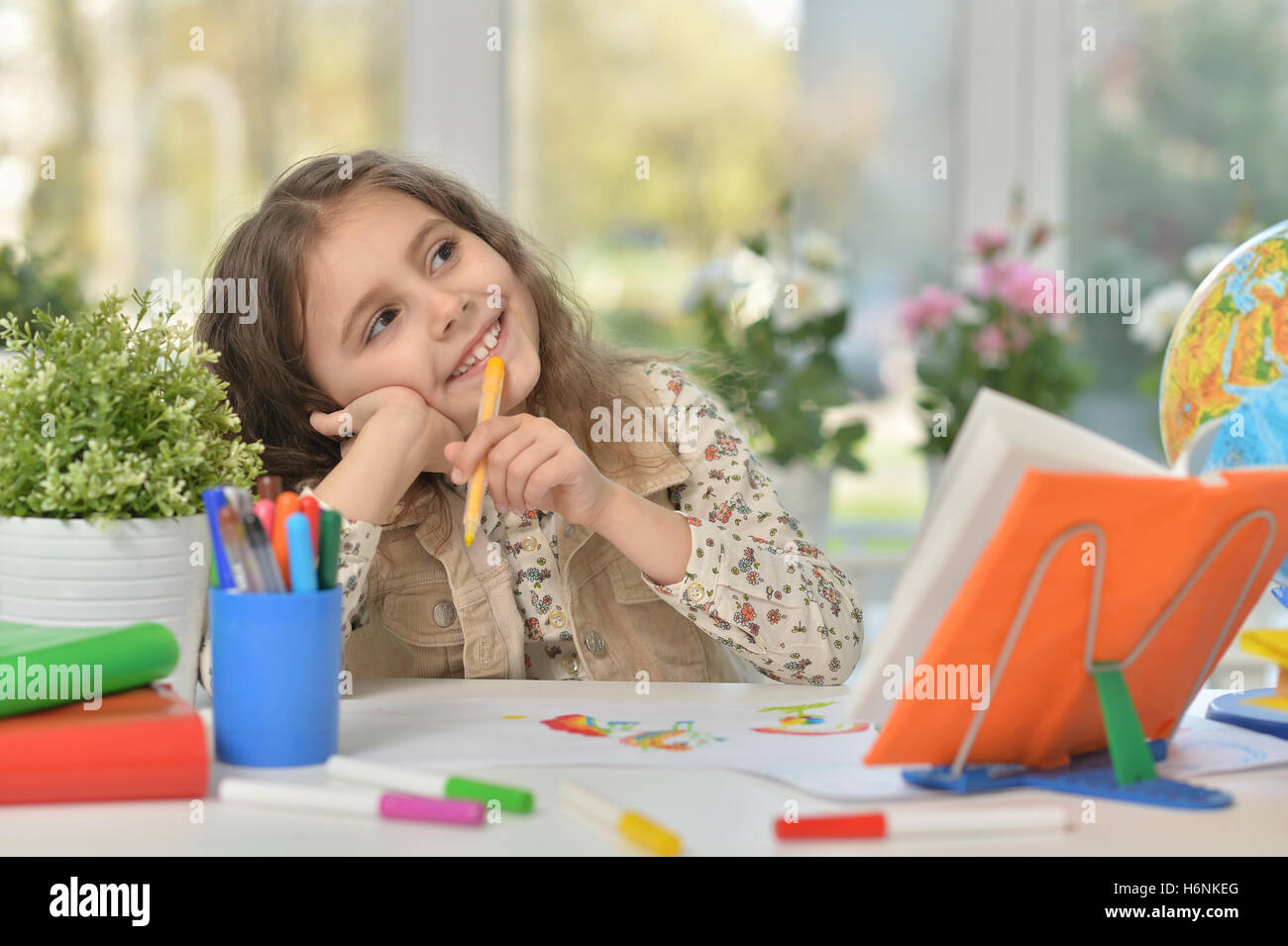 Little girl drawing at class Stock Photo - Alamy