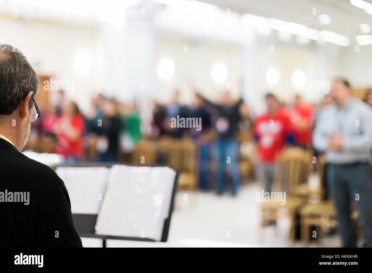 Keyboard player performing on stage live concert in front of people ...