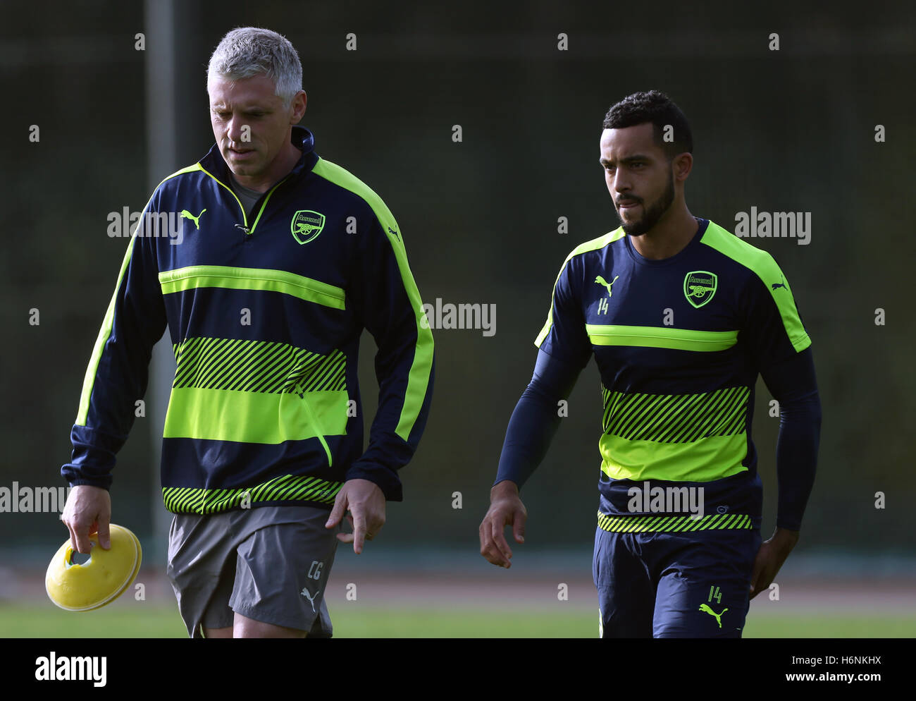 Arsenal's Theo Walcott and assistant fitness coach Craig Gant during a ...