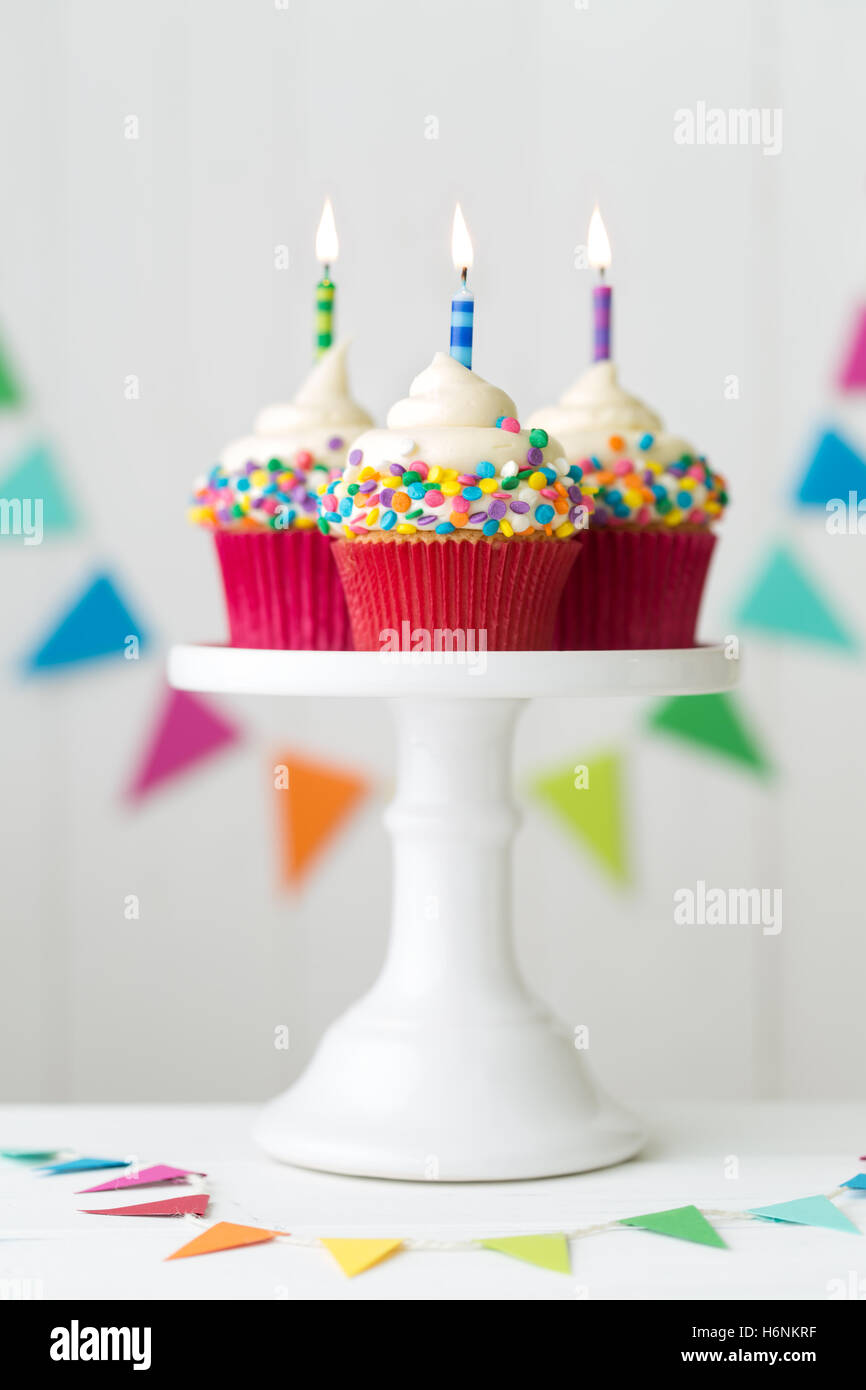 Colorful birthday cupcakes on a cake stand Stock Photo - Alamy