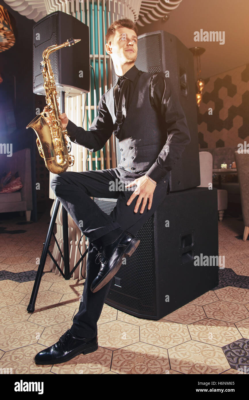 Man holding saxophone hi-res stock photography and images - Alamy
