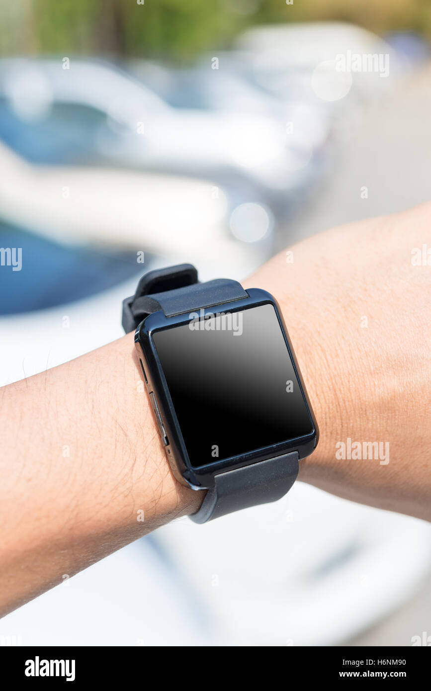 Using his smartwatch in parking car. Close-up hands Stock Photo - Alamy