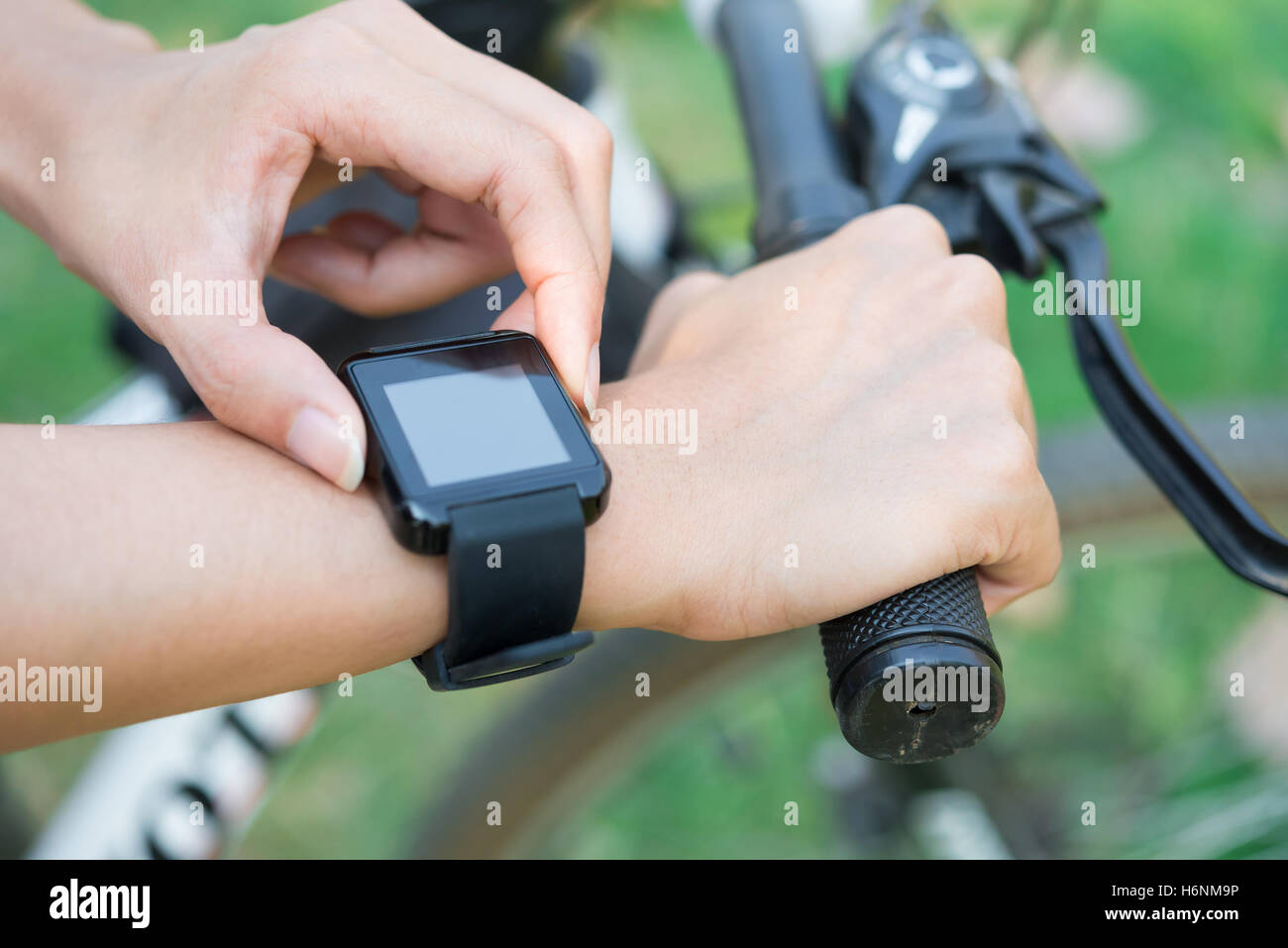 Close-up smart watch on arm women to ride a bicycle Stock Photo - Alamy