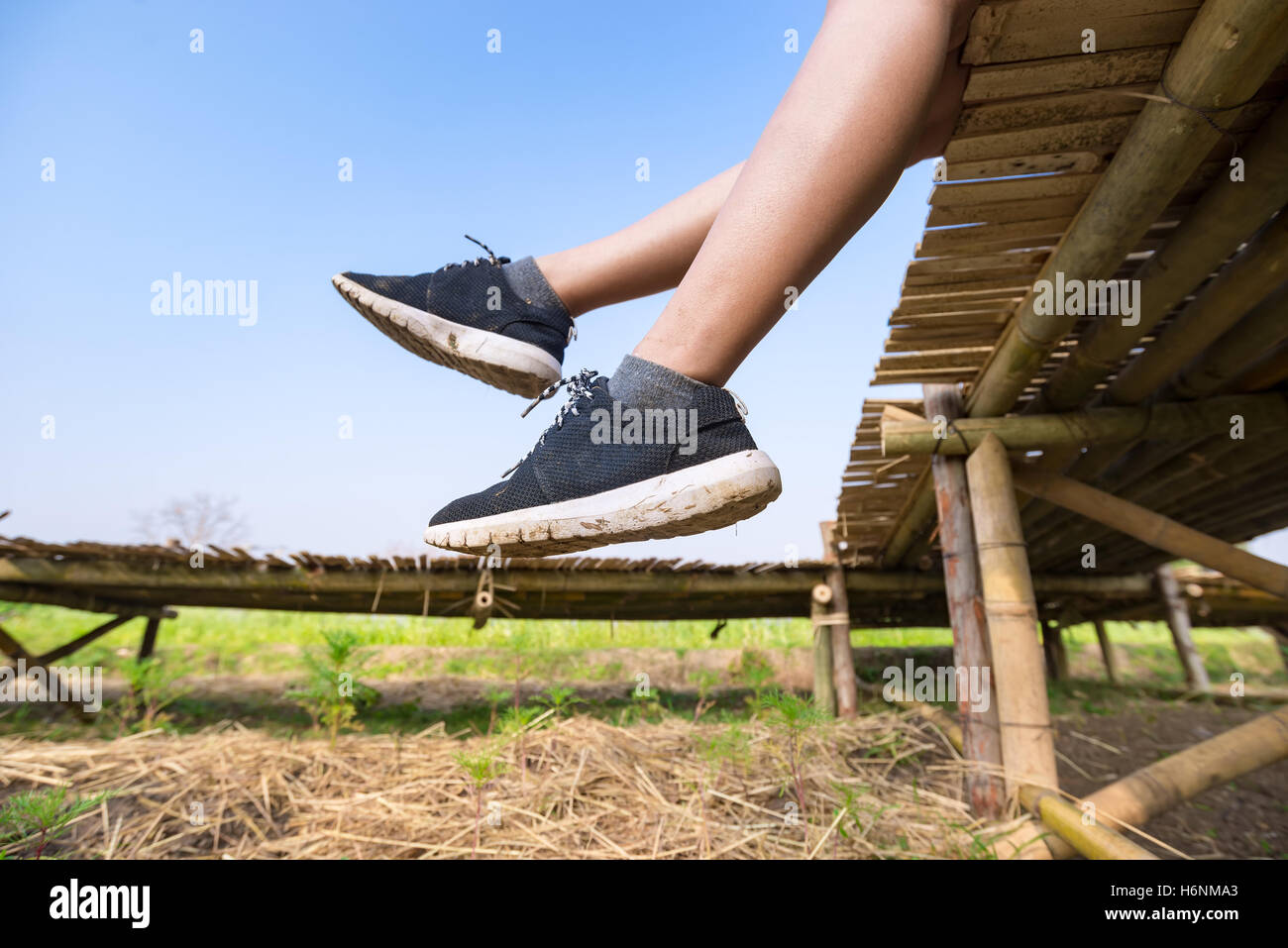 Legs woman sitting relaxing in a flower garden Stock Photo - Alamy