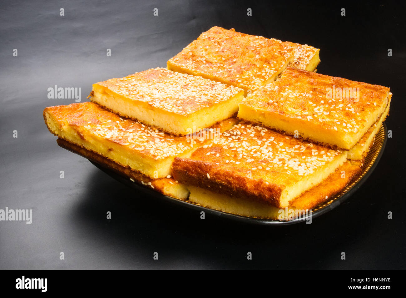 Slice of cheesecake with sesame seeds on a black background Stock Photo ...