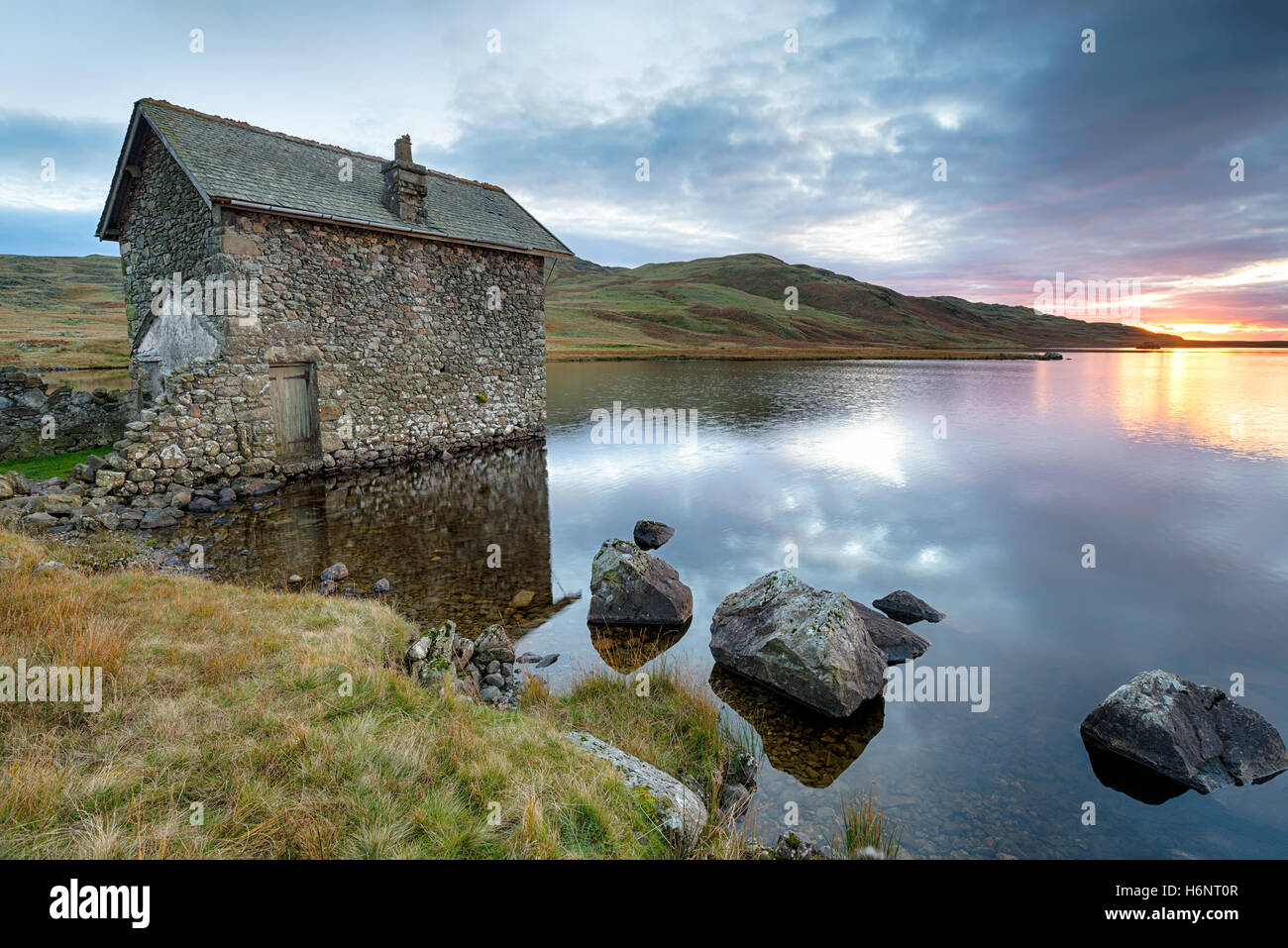 An old stone boat house on the shores of Devoke Water at the foot of ...