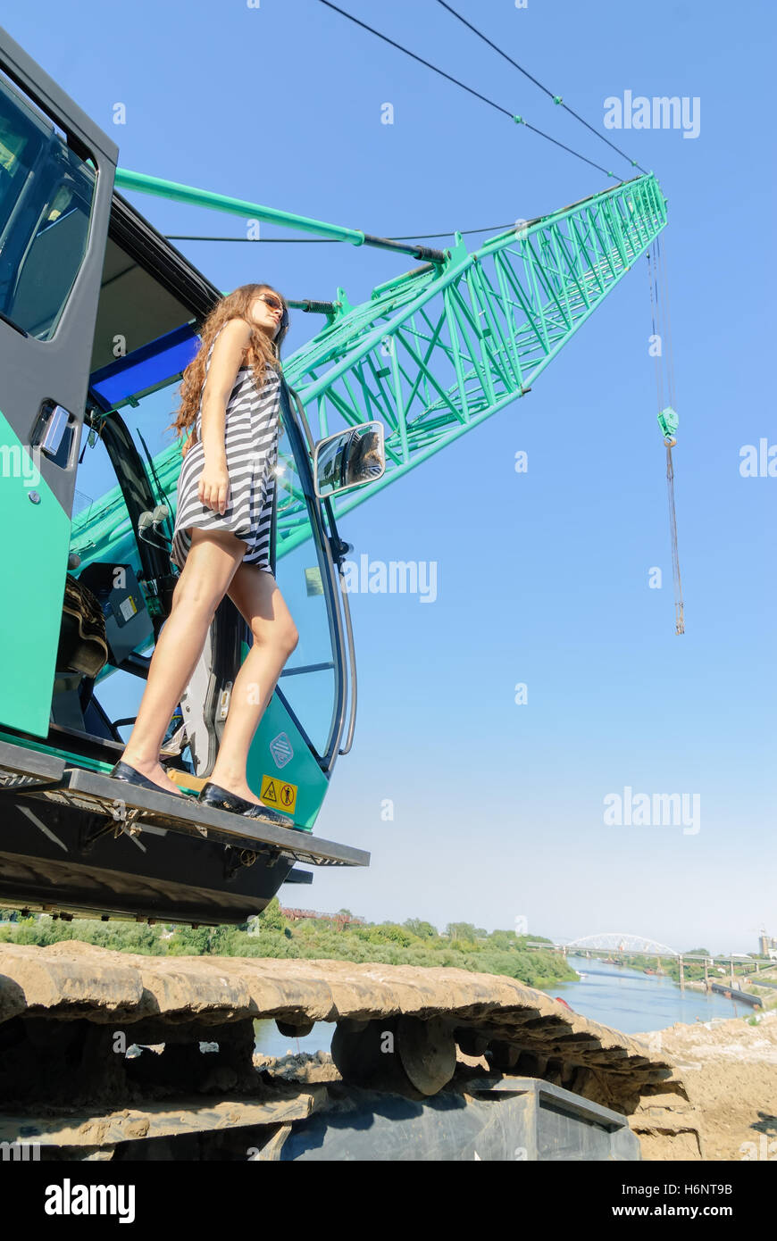 Attractive girl in construction crane cabin Stock Photo - Alamy