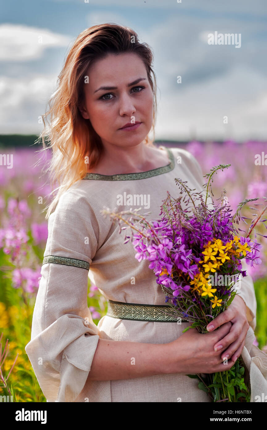 Attractive sad girl on meadow Stock Photo - Alamy