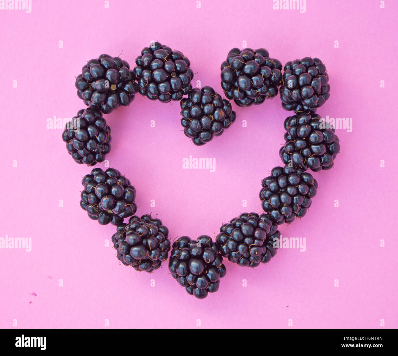 Blackberries in Heart Shape on Pink Background Stock Photo - Alamy