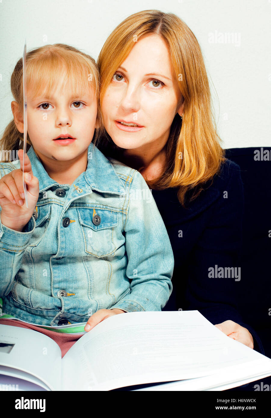 mother with daughter together in bed smiling, happy family close up ...
